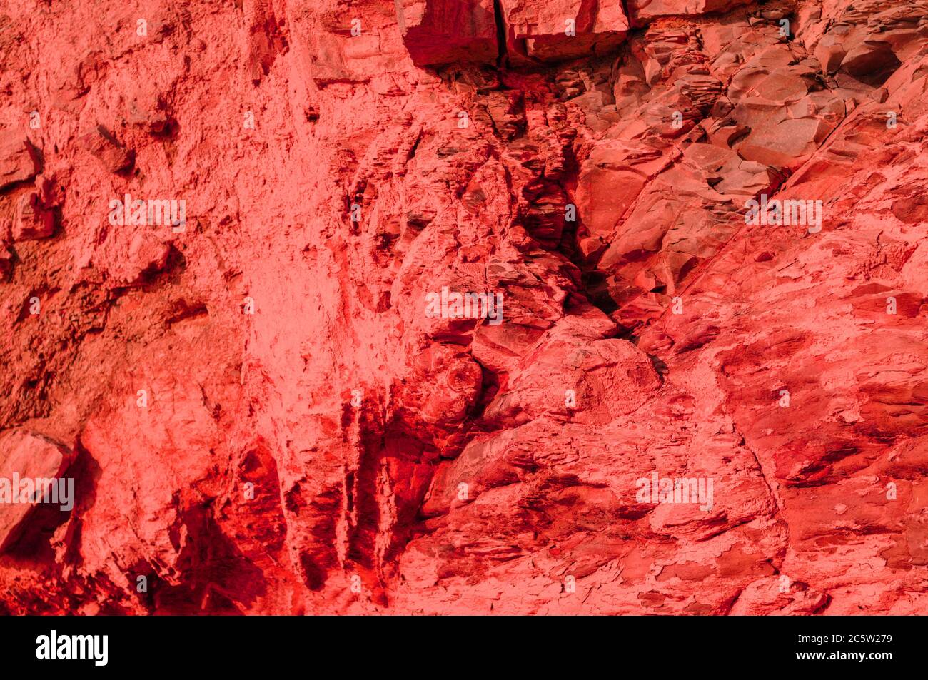 Surface with a texture of red stone. Designer background for interiors ...