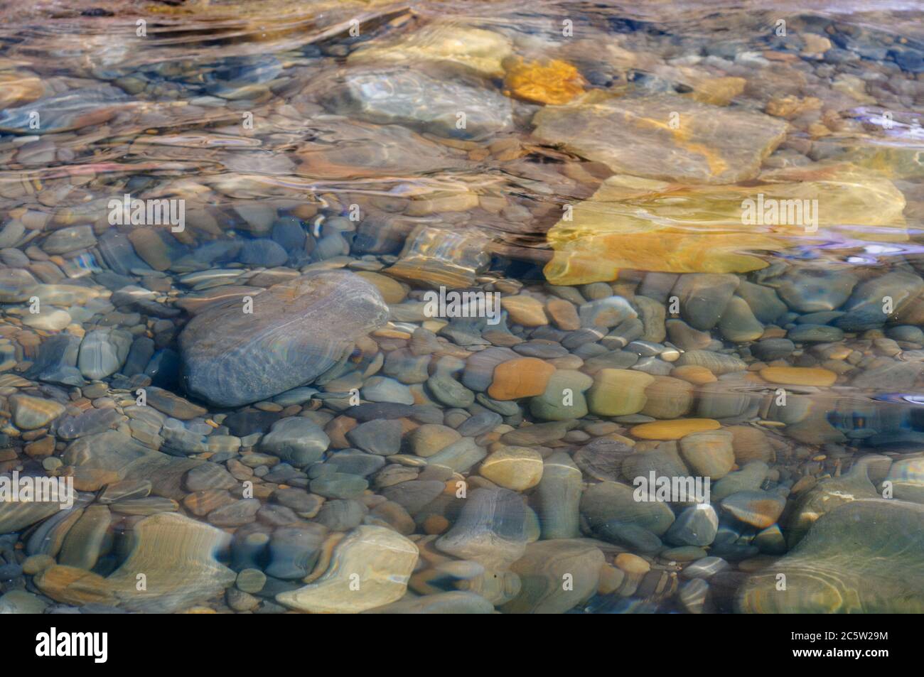 Stones in the water. Blue sea water splash. Background of sea water ...