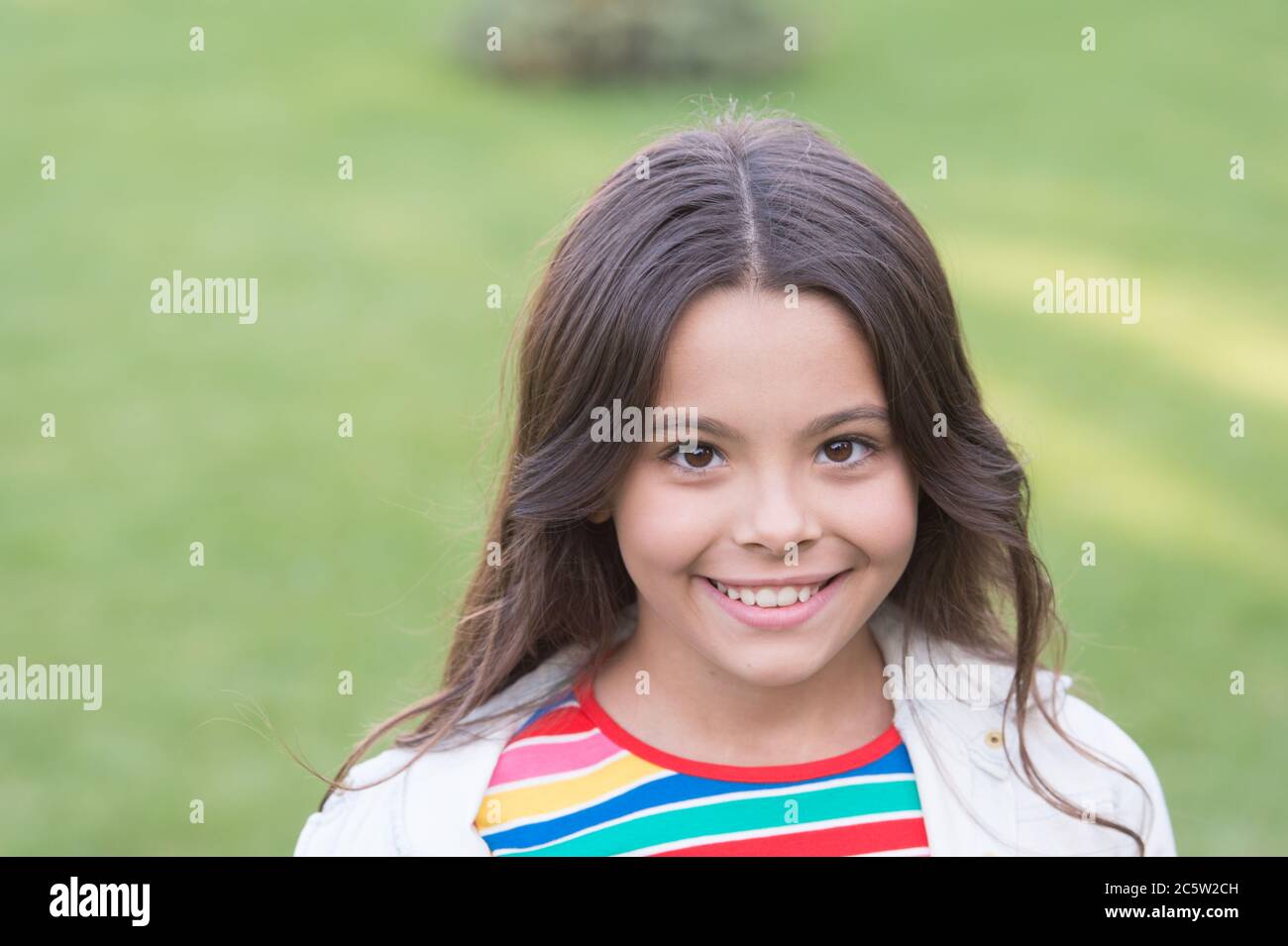 I am happy child. Cheerful schoolgirl. Girl cute kid green grass ...