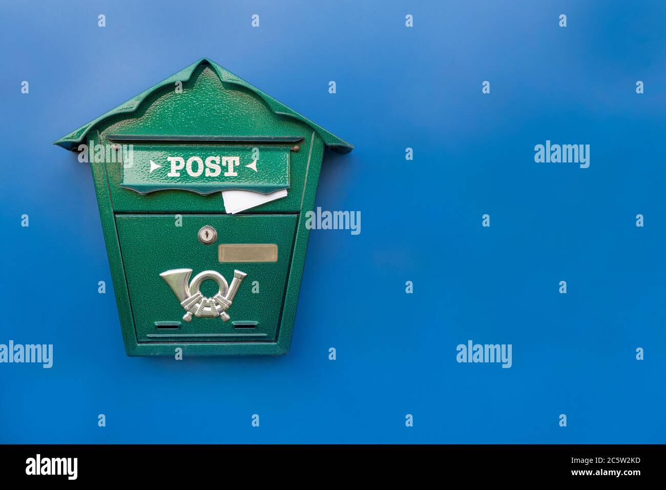 Green mailbox with sticking letter inside on a blue background Stock ...