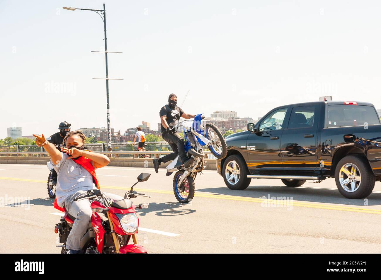 Moped street gang performing in traffic crossing the Harvard Bridge in ...