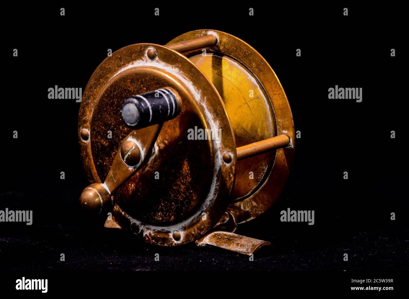 One Vintage Old Metal Fishing Reel on a Black Background Stock Photo ...