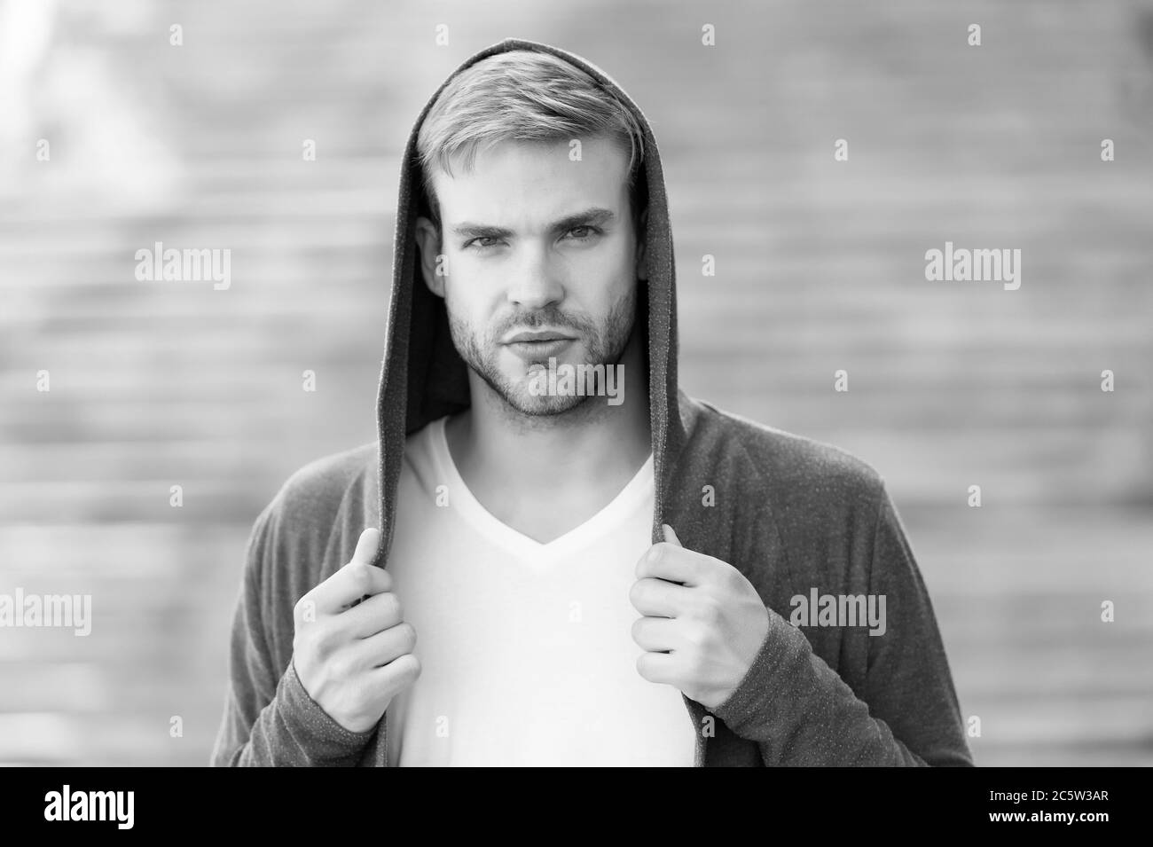 Perfect male. Fashionable young model man. man posing with hoodie ...