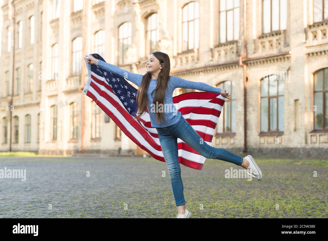 Patriotic upbringing. Patriotic child hold american flag outdoors ...