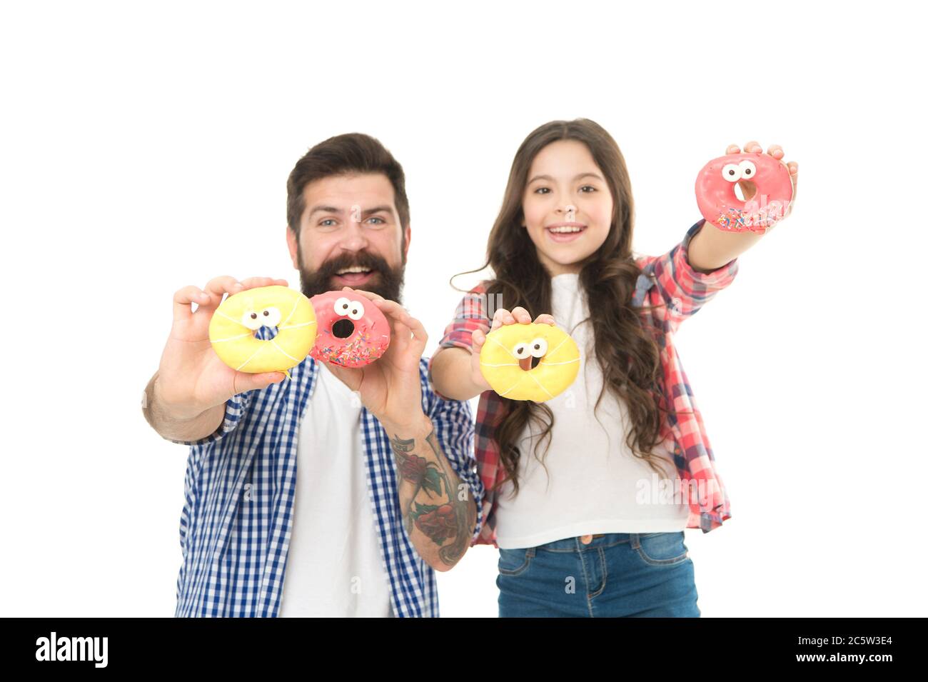Sweet tooth. Girl child and dad hold glazed donuts. Cheerful family ...
