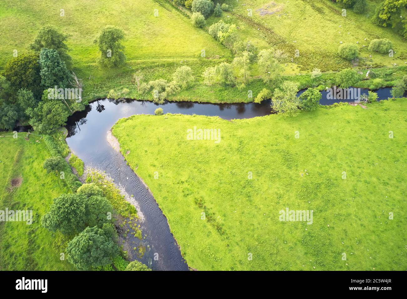 Aerial view of river and empty green meadow field Stock Photo - Alamy