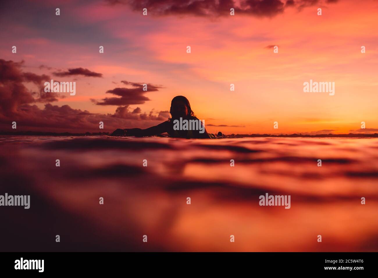 April 16, 2020. Bali, Indonesia. Surf girl relax on surfboard. Surfers ...