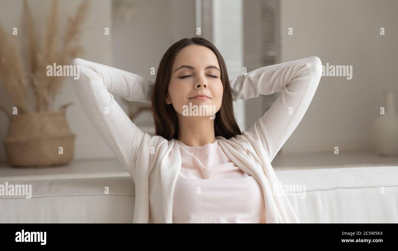 Close up calm peaceful young woman relaxing on cozy couch Stock Photo ...