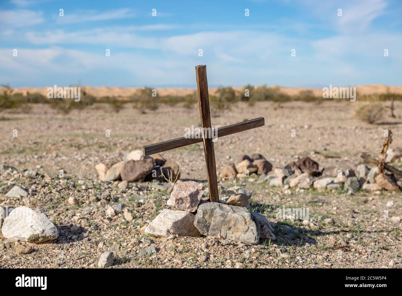 A cross on an unmarked grave, in a small roadside cemetery near The ...