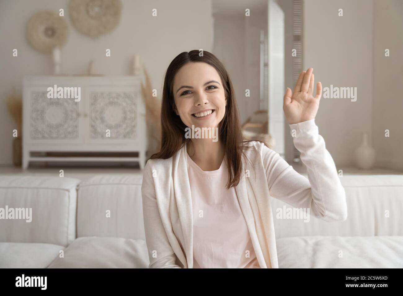 Head shot portrait smiling beautiful woman waving hand at camera Stock ...