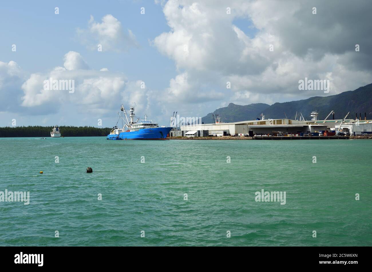 Mahe, Seychelles - June 27, 2011: Blue ship shown in the cargo port of ...