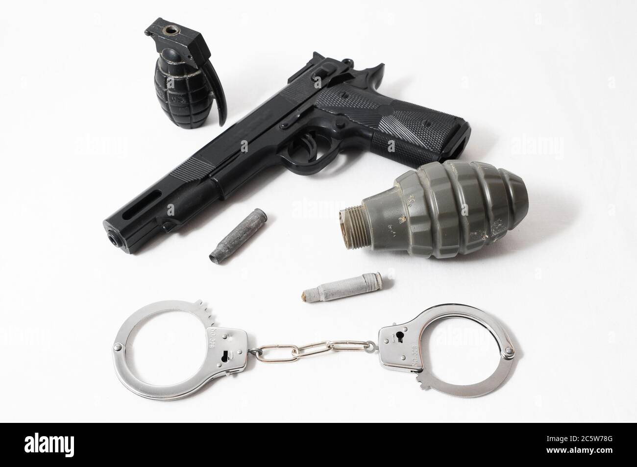 Grenade Bullets Gun and Handcuffs on a White Background Stock Photo - Alamy