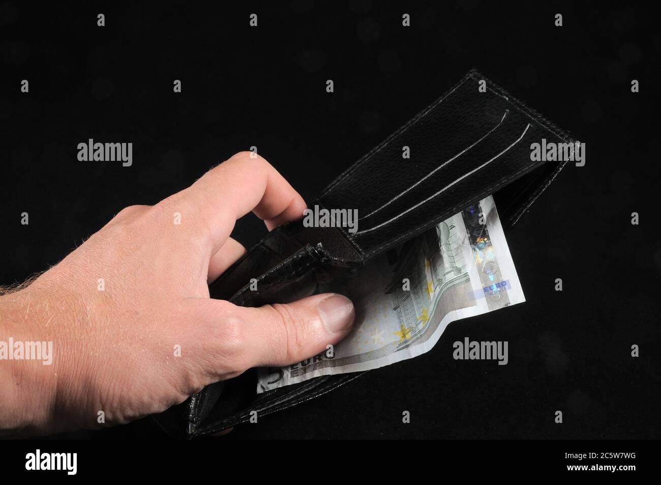 Wallet with euro currency on a dark background Stock Photo - Alamy