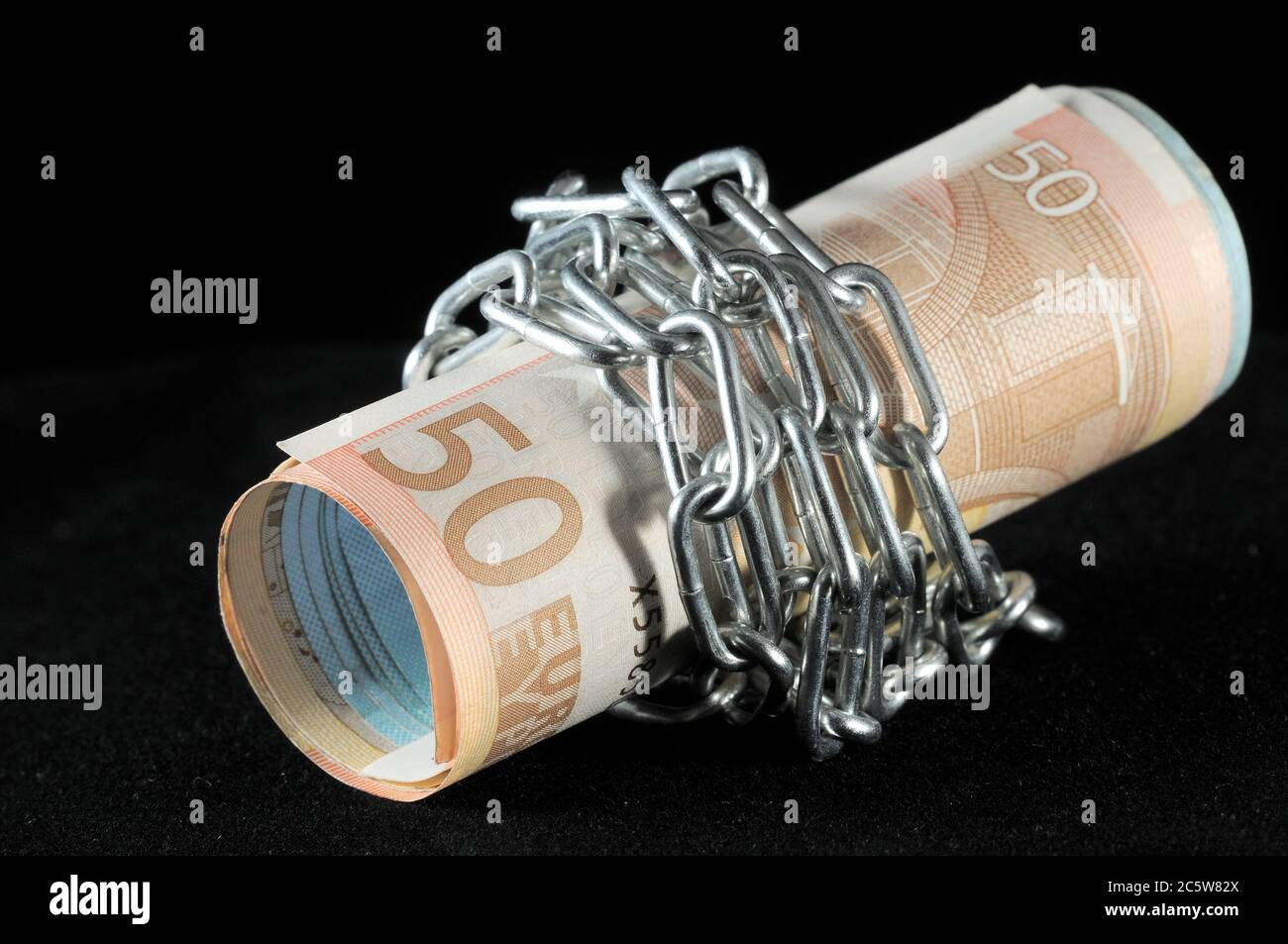 Money in chains that represents the crisis on a black background Stock ...
