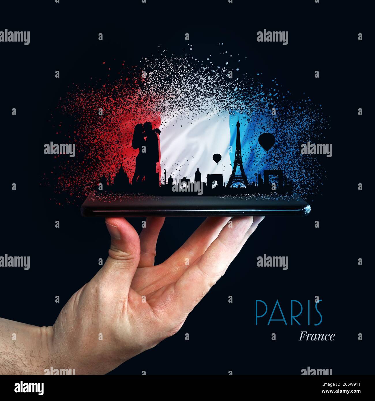 Paris (France). Hand holds cell phone with colorful flag splattering on ...
