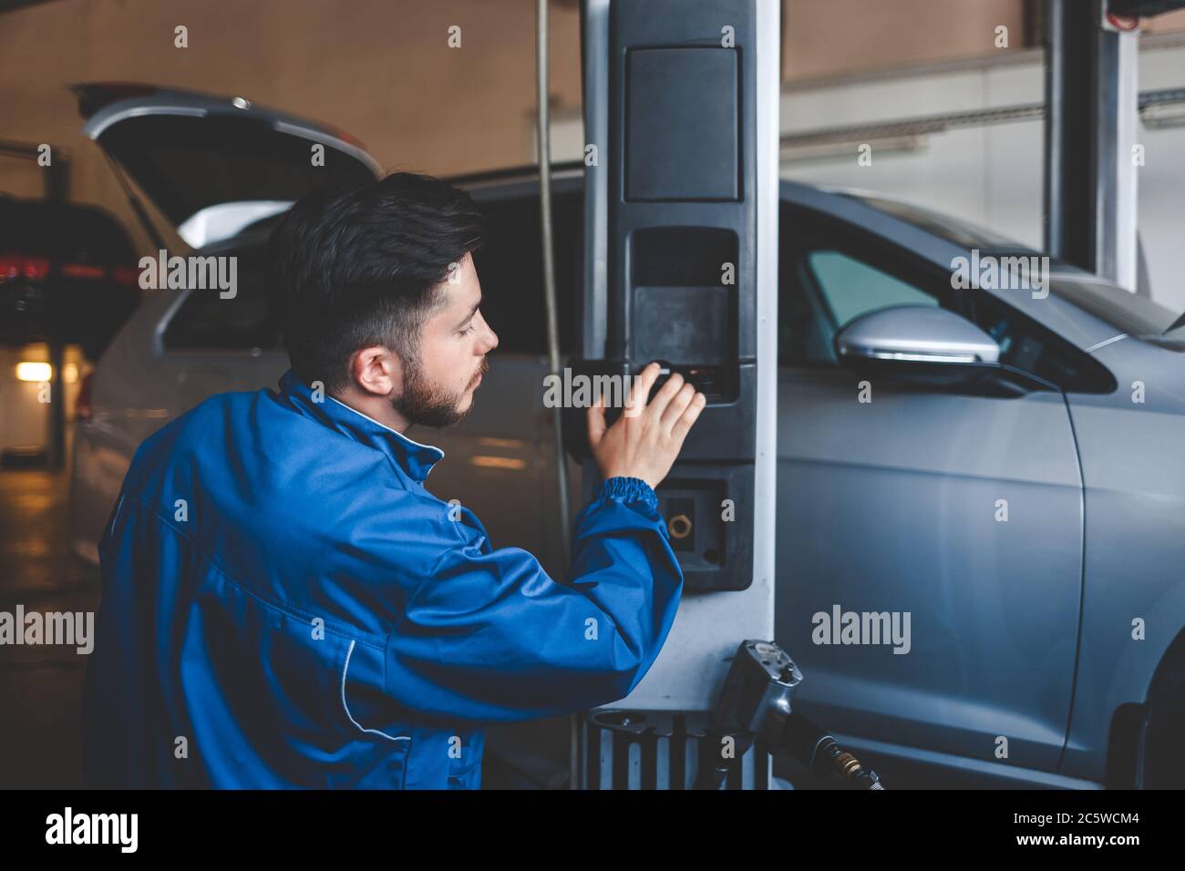 Man lifts car hi-res stock photography and images - Alamy