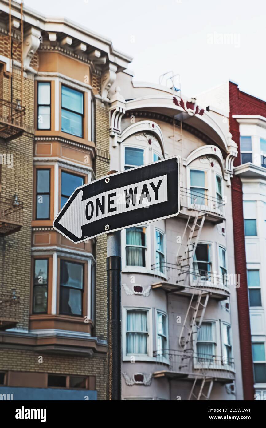 One Way street sign with victorian houses on the background in San ...
