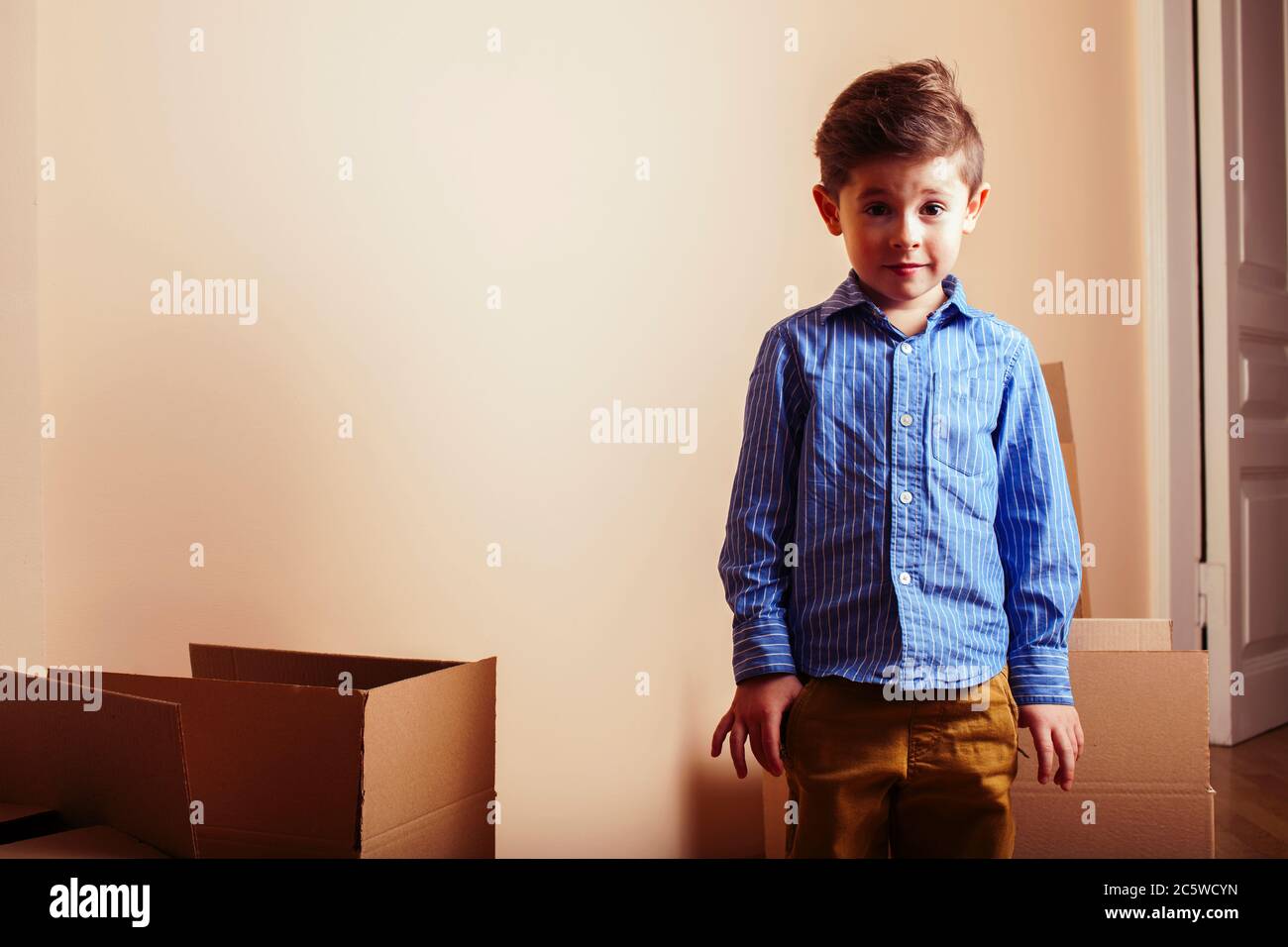 little cute boy in empty room, move to new house. home alone among ...