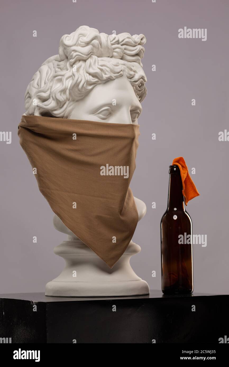 White plaster statue of a bust of Apollo Belvedere in a headscarf ...