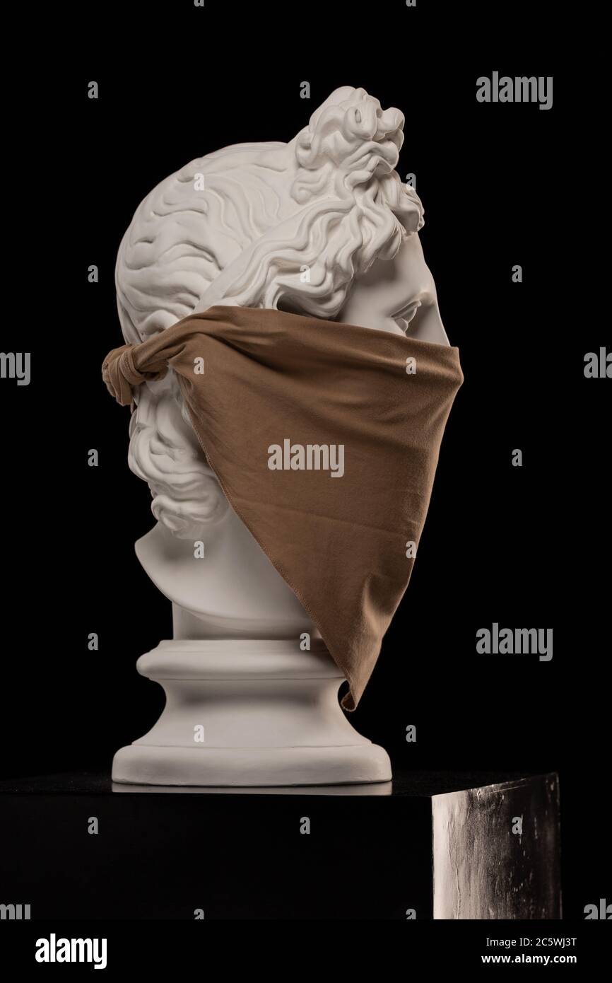 White plaster statue of a bust of Apollo Belvedere in a headscarf ...