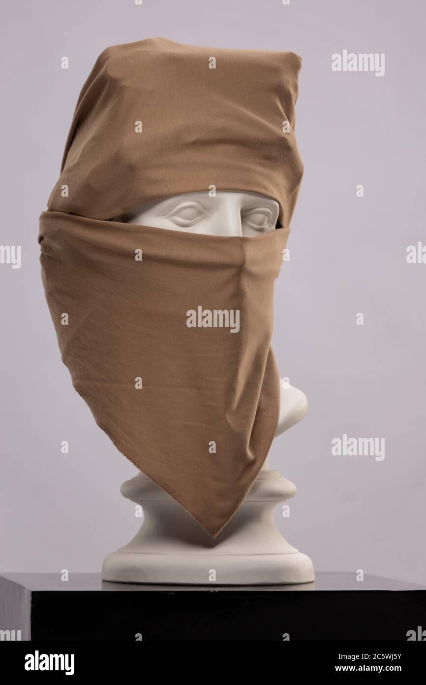White plaster statue of a bust of Apollo Belvedere in hijab niqab Stock ...
