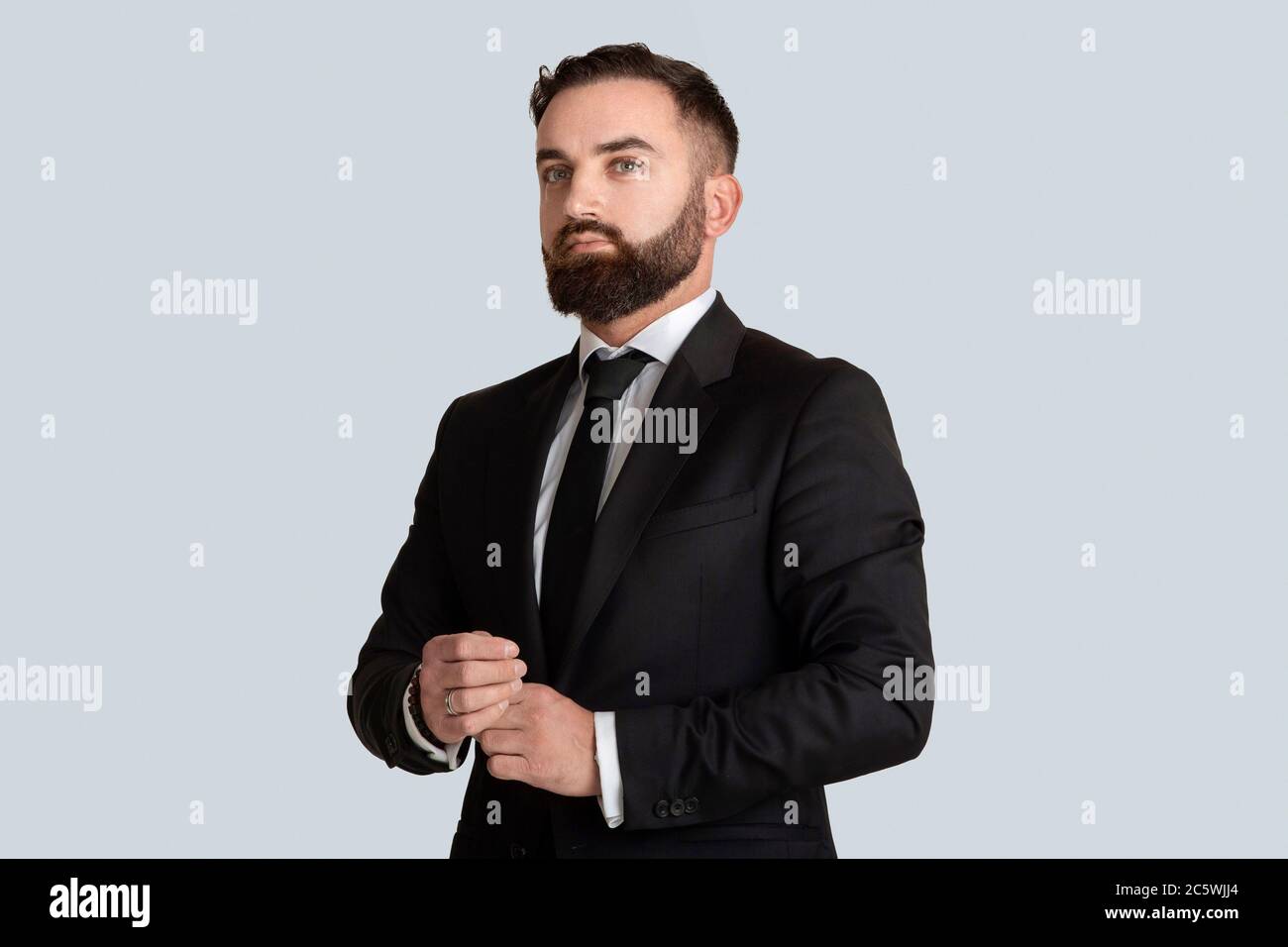 Elegant businessman in formal suit and tie on grey background Stock ...