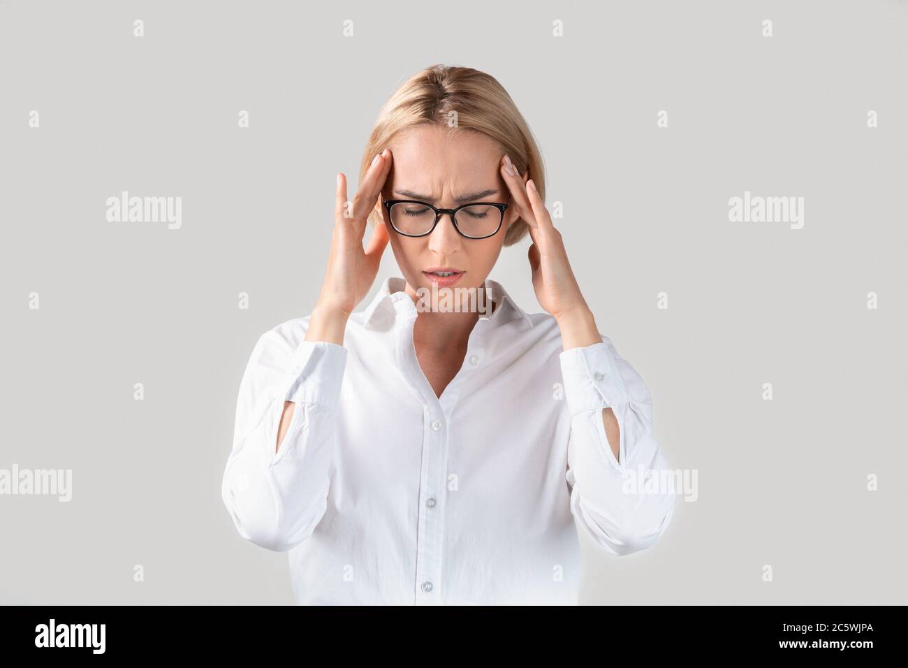 Tired office employee having terrible headache or suffering from work ...