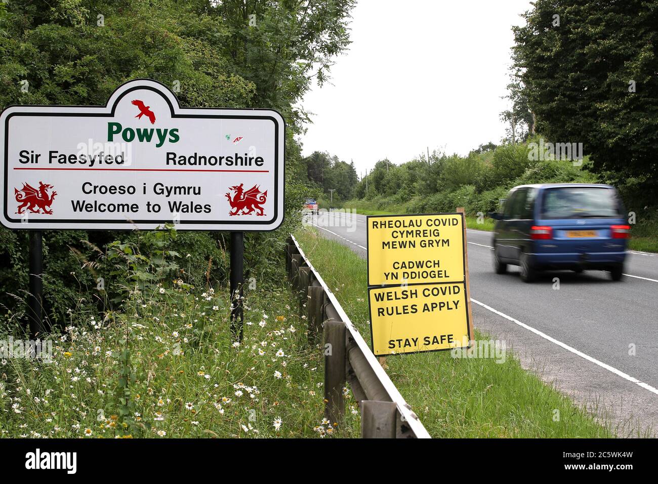 A car drives past the Wales border line between Wales and England ...