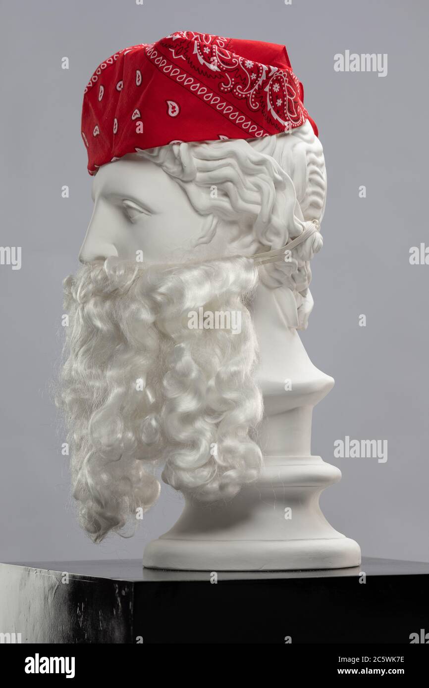 White plaster statue of a bust of Apollo Belvedere with a long white ...