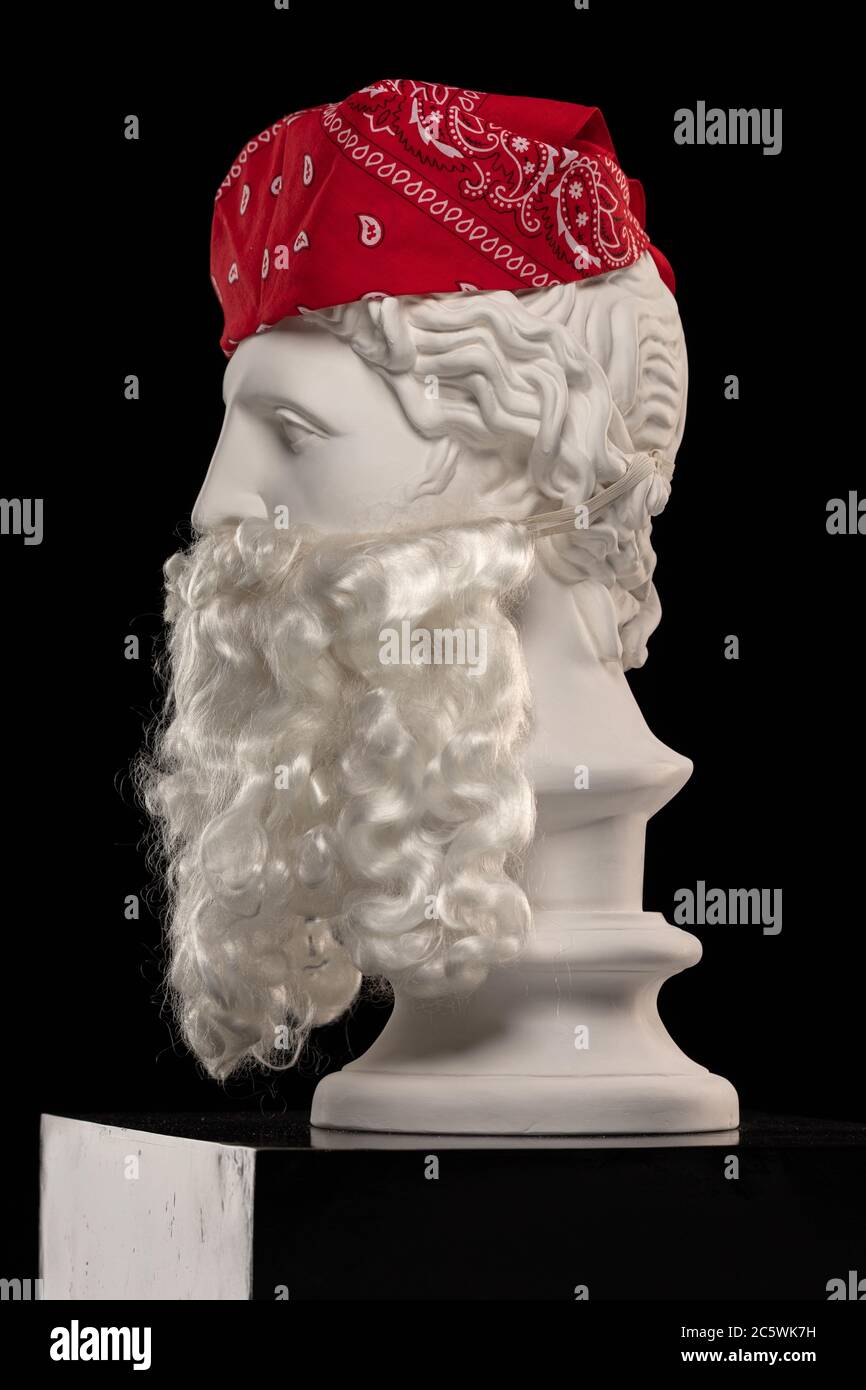 White plaster statue of a bust of Apollo Belvedere with a long white ...