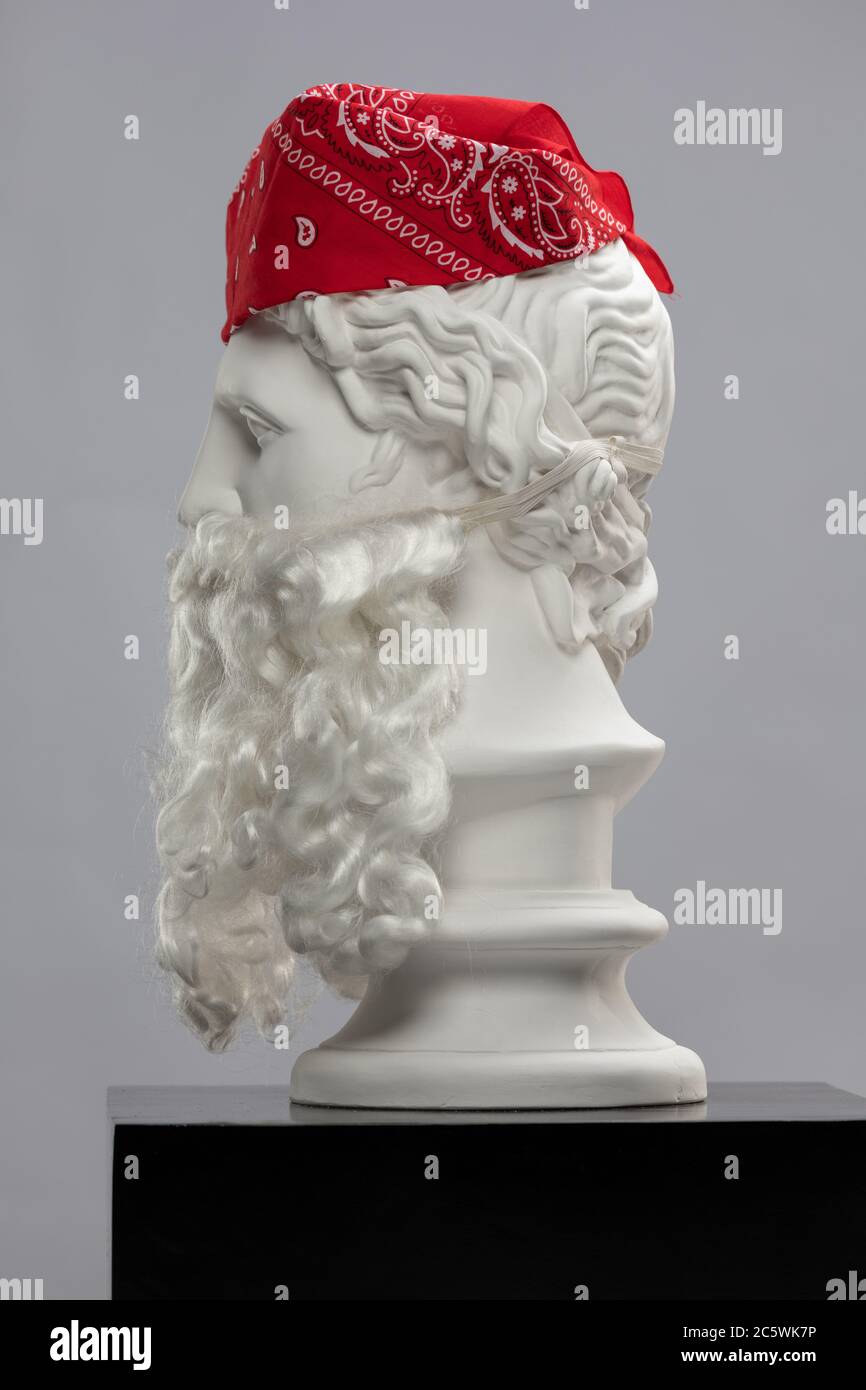 White plaster statue of a bust of Apollo Belvedere with a long white ...