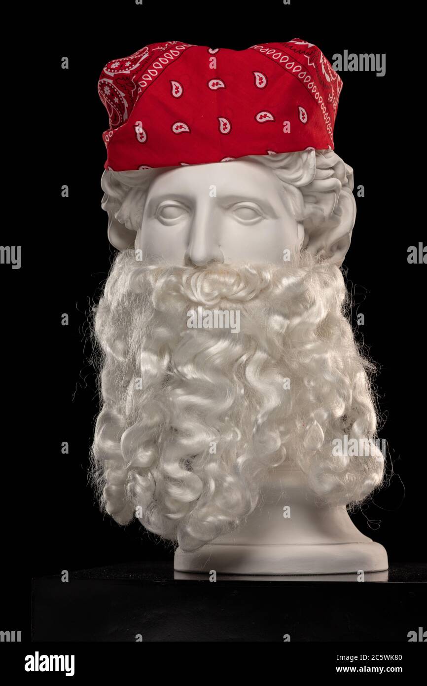 White plaster statue of a bust of Apollo Belvedere with a long white ...