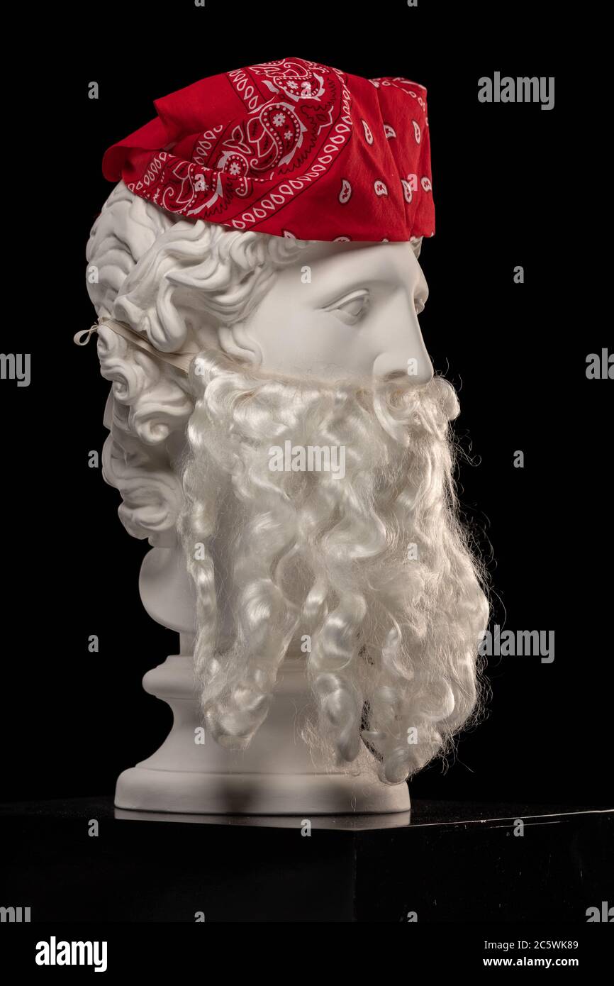 White plaster statue of a bust of Apollo Belvedere with a long white ...