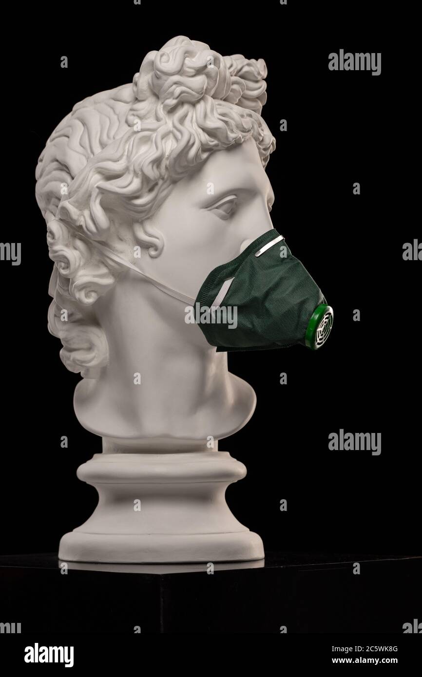 Protective mask, respirator on the face of the statue of Apollo Stock ...