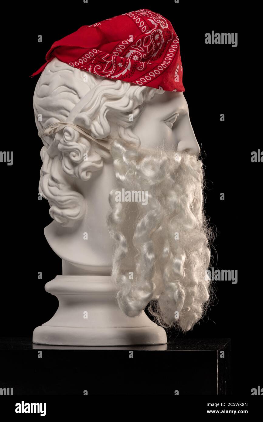 White plaster statue of a bust of Apollo Belvedere with a long white ...