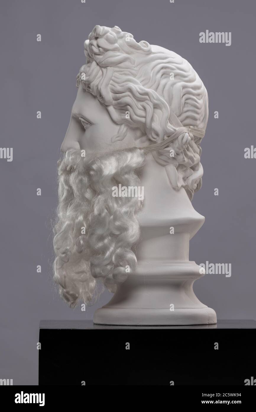 White plaster statue of a bust of Apollo Belvedere with a long white ...