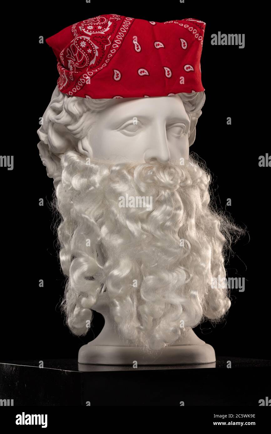 White plaster statue of a bust of Apollo Belvedere with a long white ...