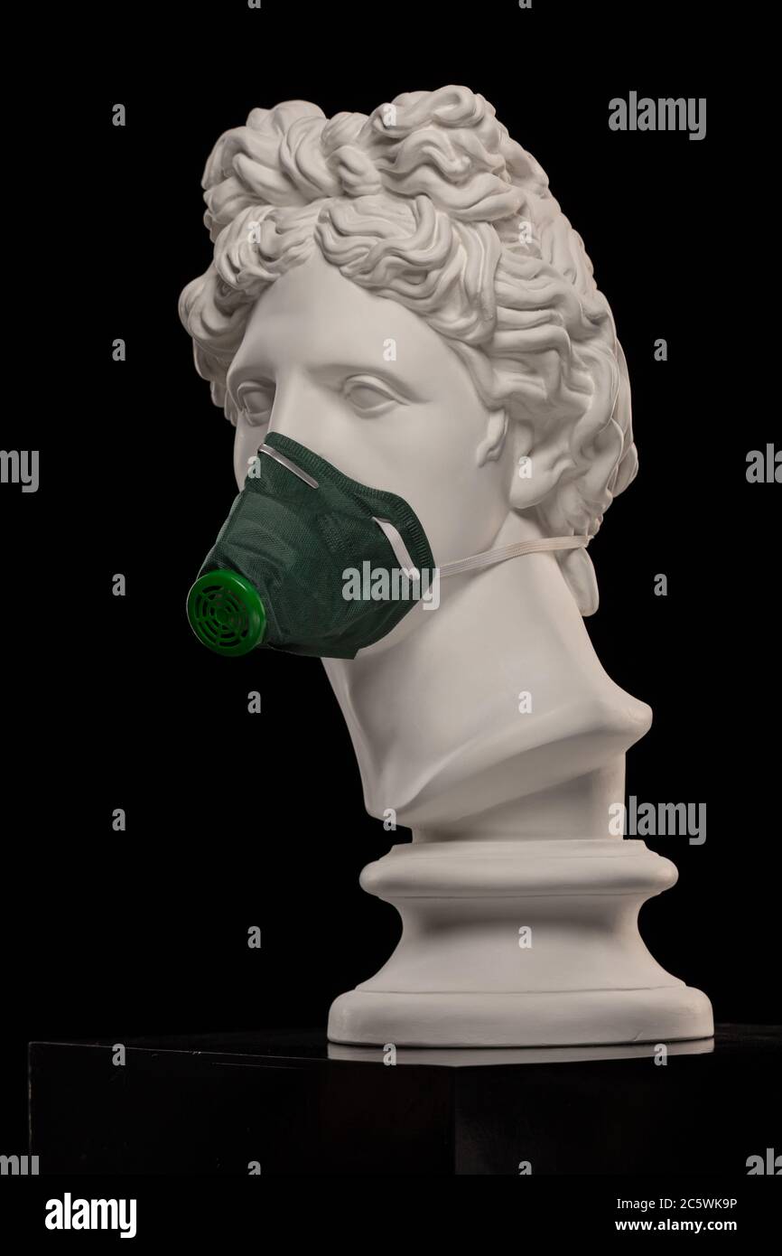 Protective mask, respirator on the face of the statue of Apollo Stock ...