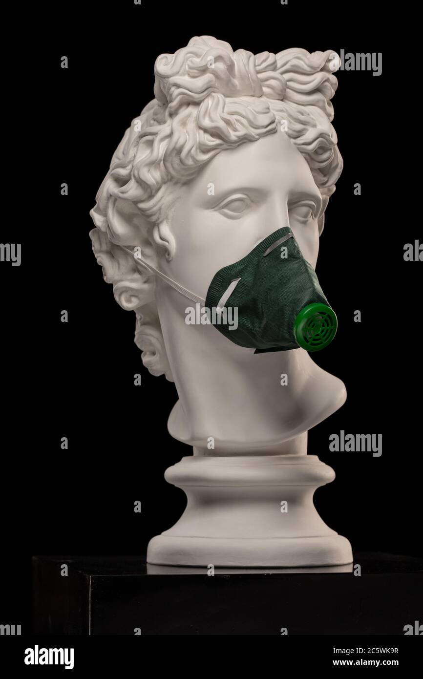 Protective mask, respirator on the face of the statue of Apollo Stock ...