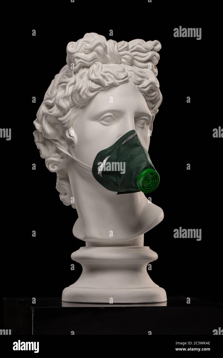 Protective mask, respirator on the face of the statue of Apollo Stock ...