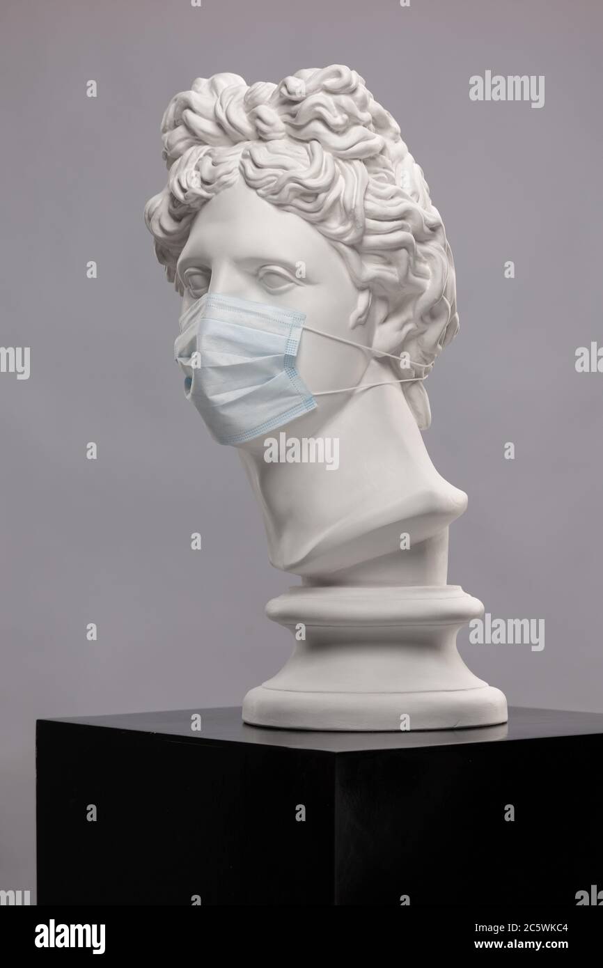 Medical protective mask on the face of the statue of Apollo Stock Photo ...