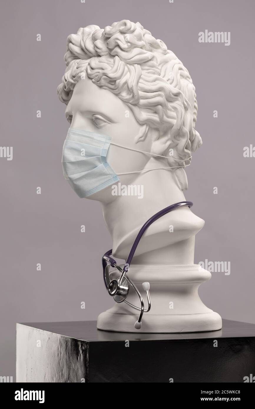 Bust of Apollo Belvedere in a disposable protective mask covering his ...