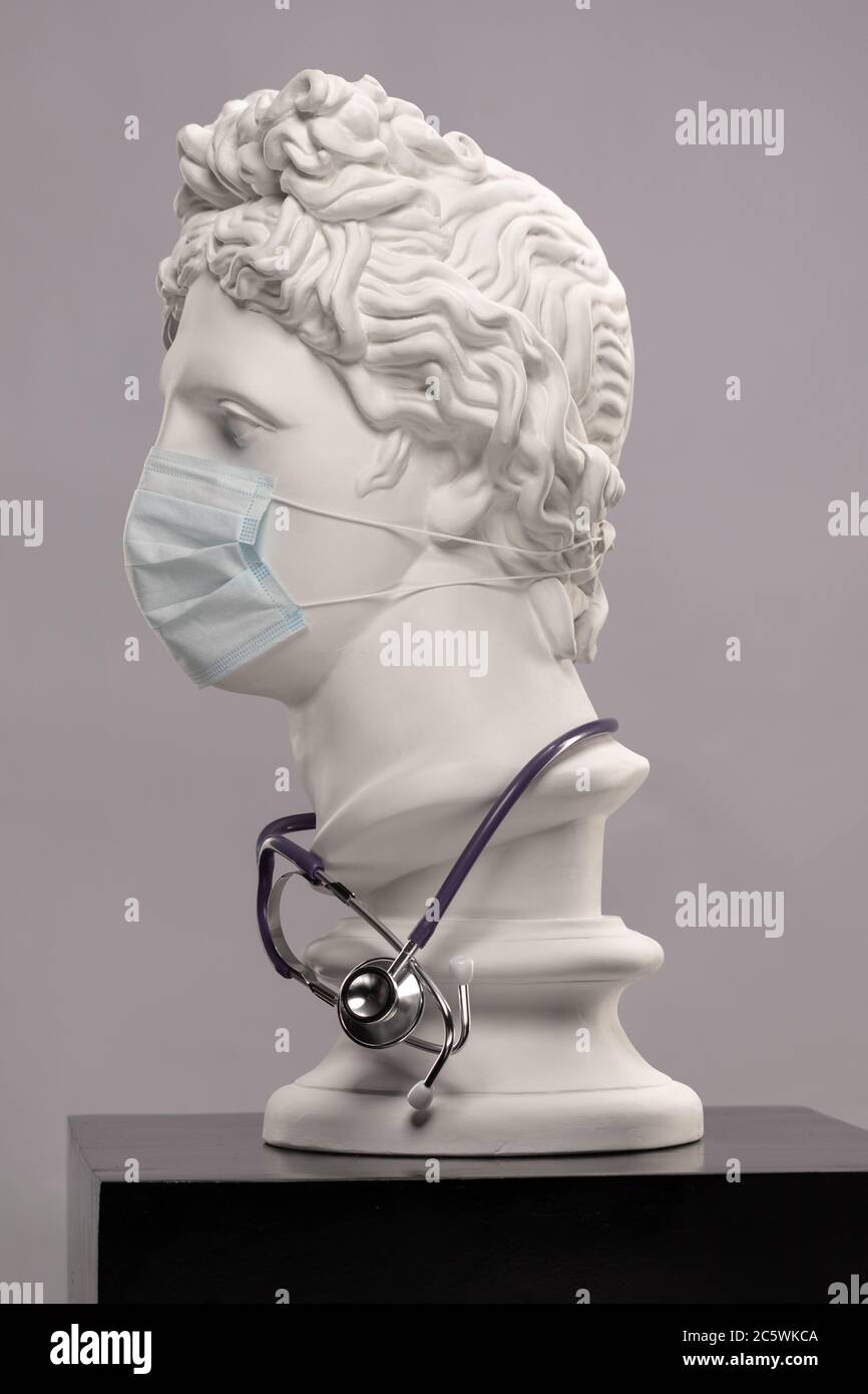Bust of Apollo Belvedere in a disposable protective mask covering his ...