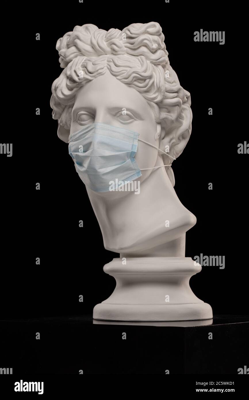 Medical protective mask on the face of the statue of Apollo Stock Photo ...