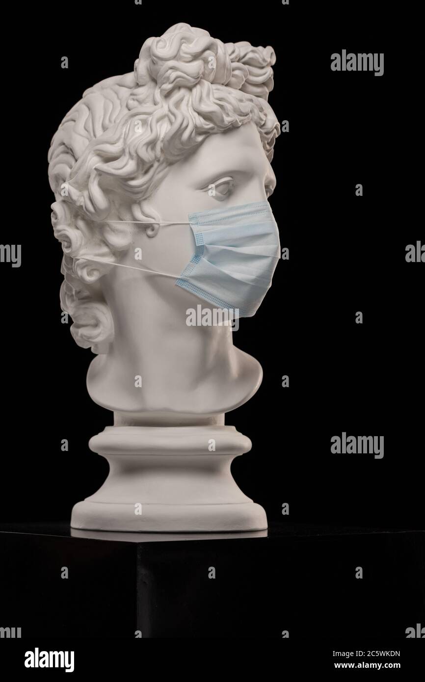 Medical protective mask on the face of the statue of Apollo Stock Photo ...