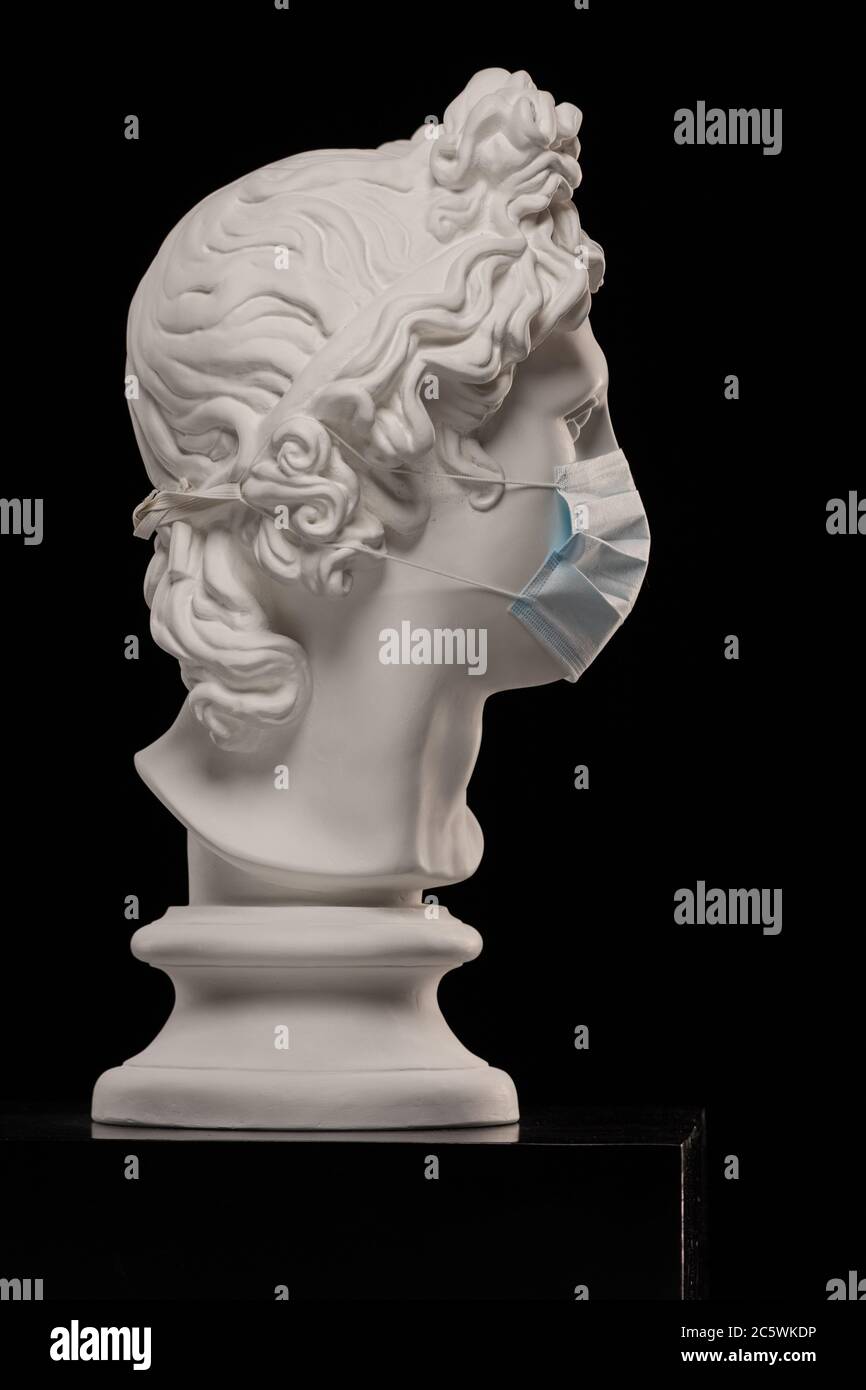 Medical protective mask on the face of the statue of Apollo Stock Photo ...