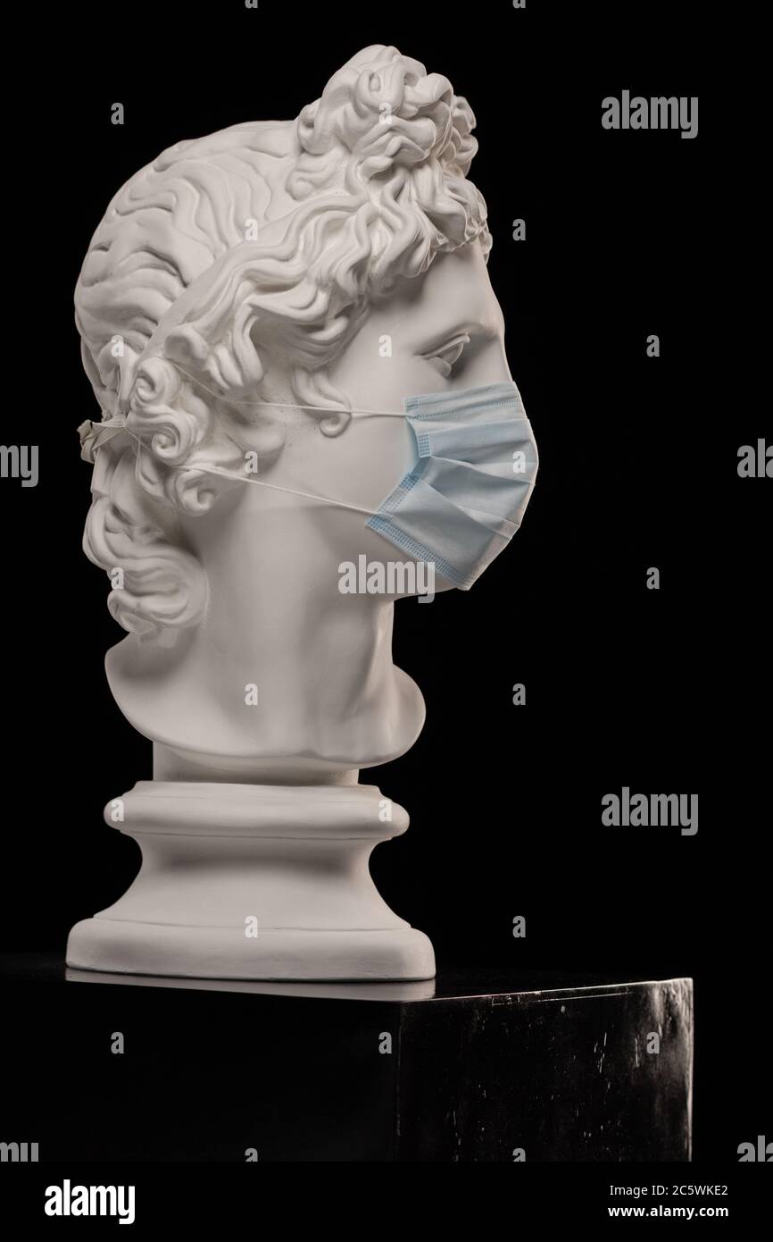 Medical protective mask on the face of the statue of Apollo Stock Photo ...