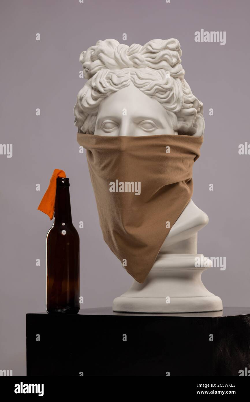 Statue of a bust of Apollo's head in a headscarf covering his face and ...