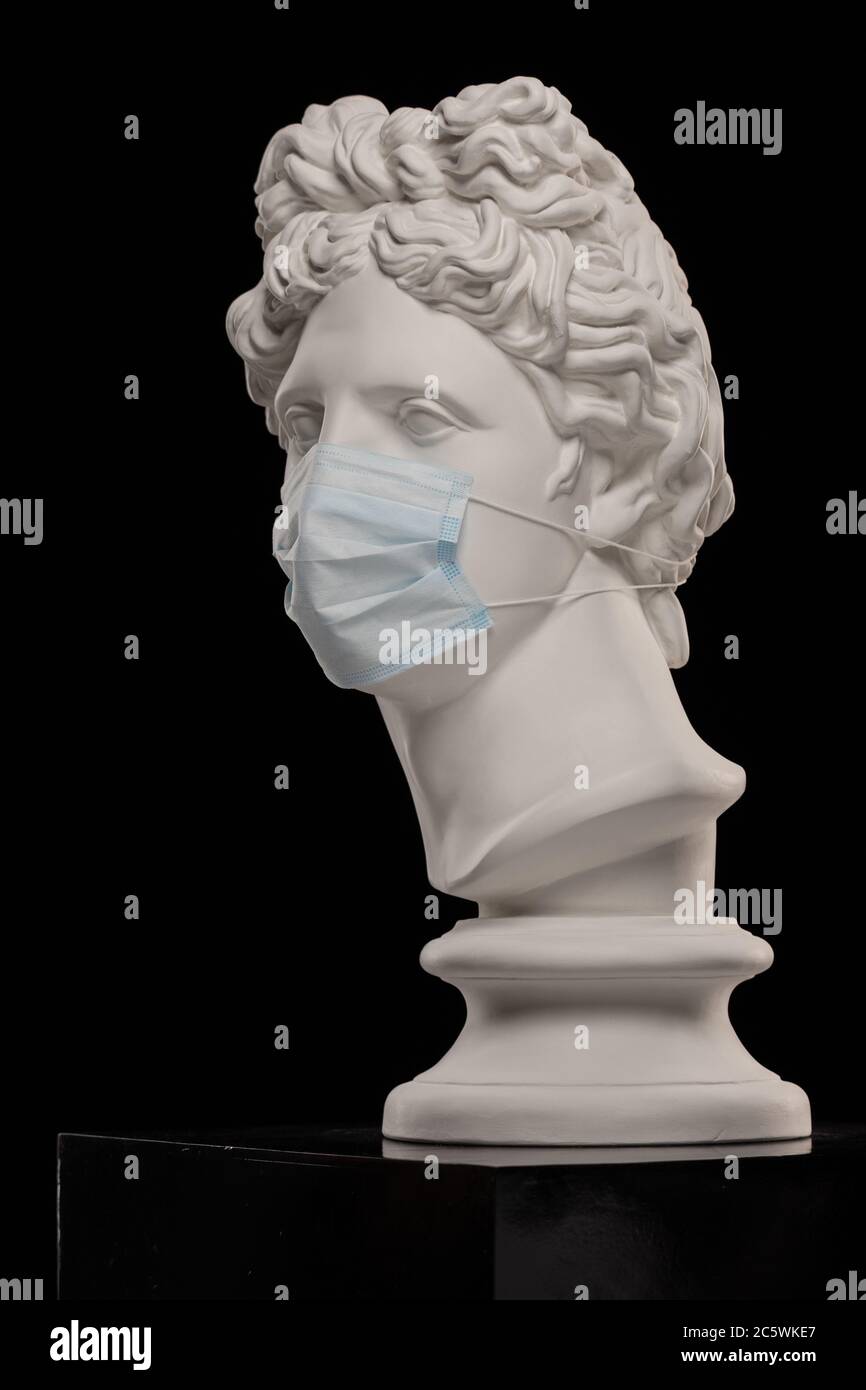 Medical protective mask on the face of the statue of Apollo Stock Photo ...