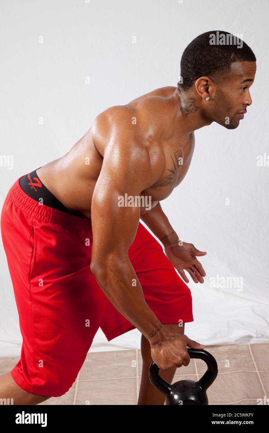 Handsome Black man working out with a kettle bell Stock Photo - Alamy